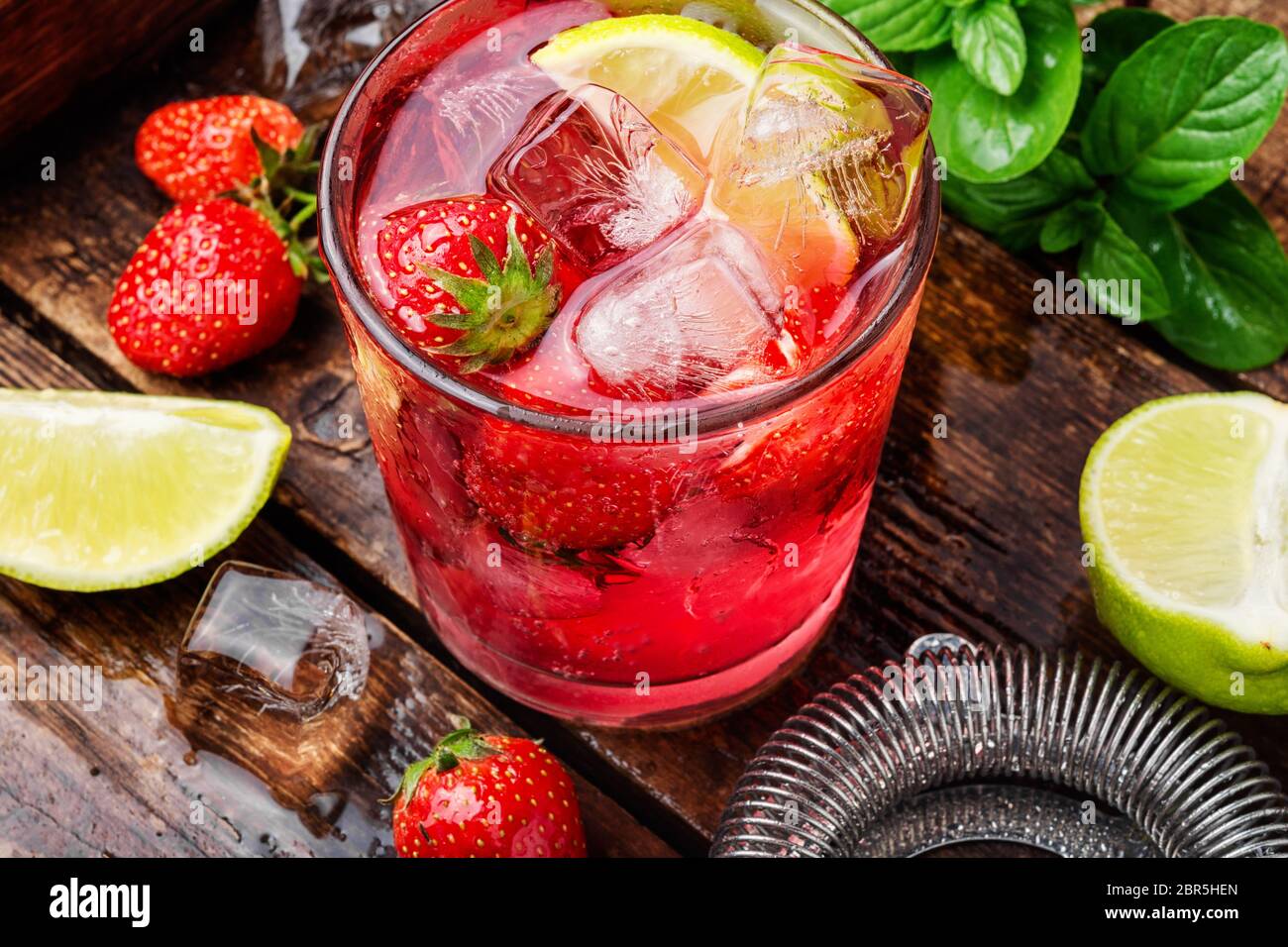 Strawberry cocktail with lime and ice.Ice cold strawberry lemonade ...