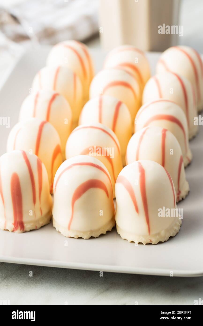 Sweet foam dessert. Marshmallow covered with strawberry icing on plate ...