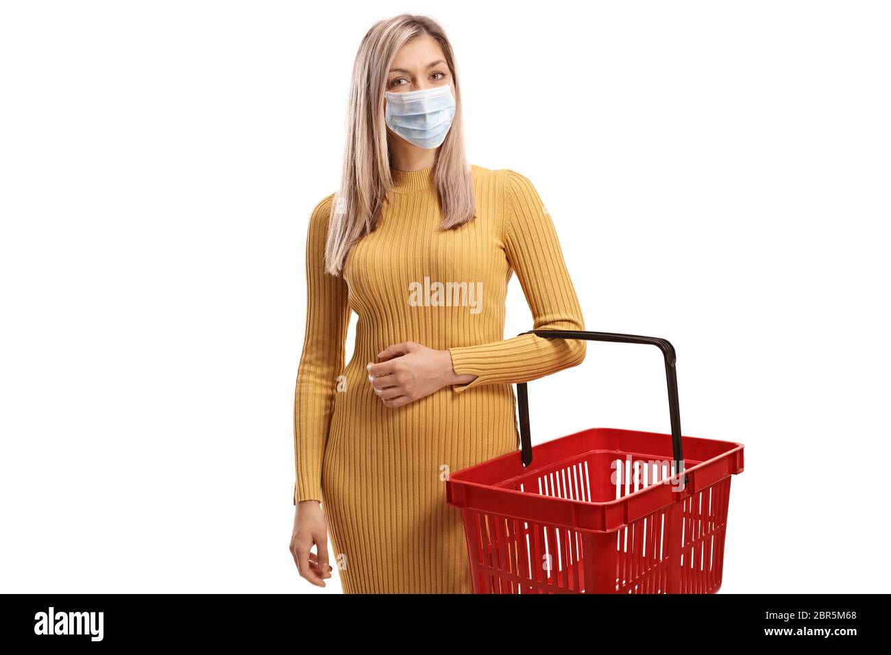 Woman with a shopping basket wearing a protective face mask isolated on ...