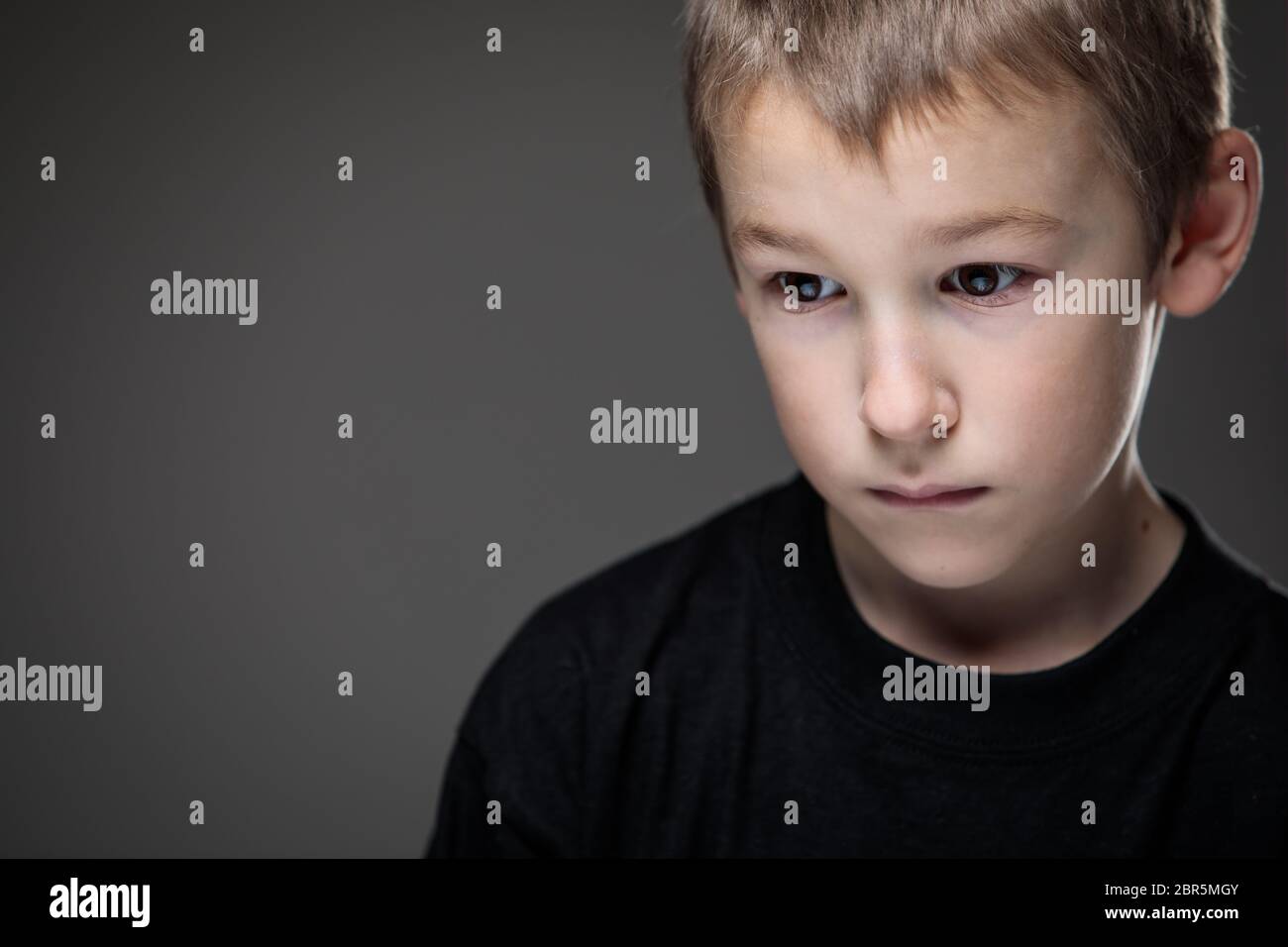 Grief-stricken little boy - feeling intense sorrow, remorse, sadnesss ...