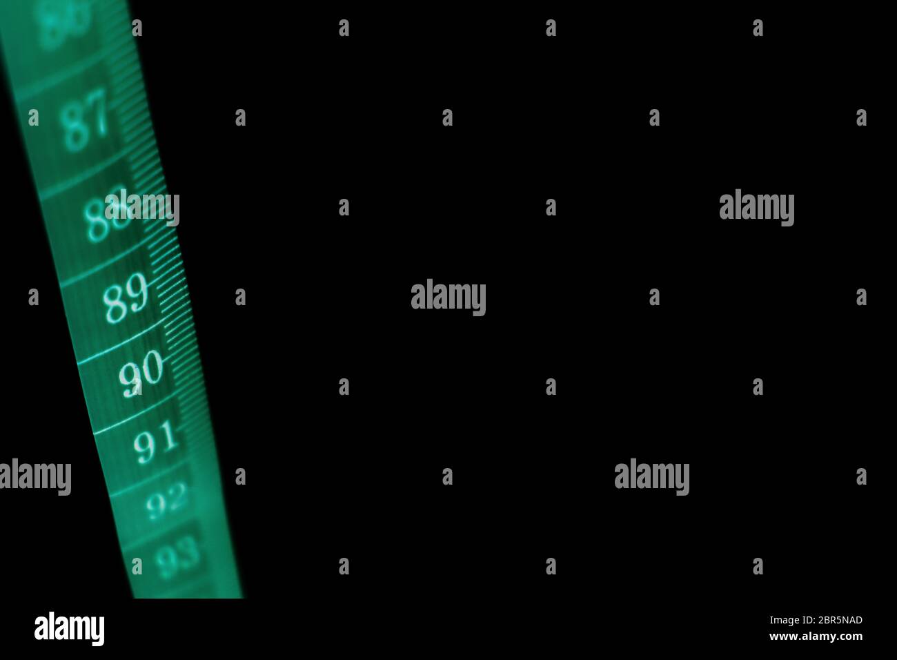 A concept black background with a tape measure Stock Photo - Alamy