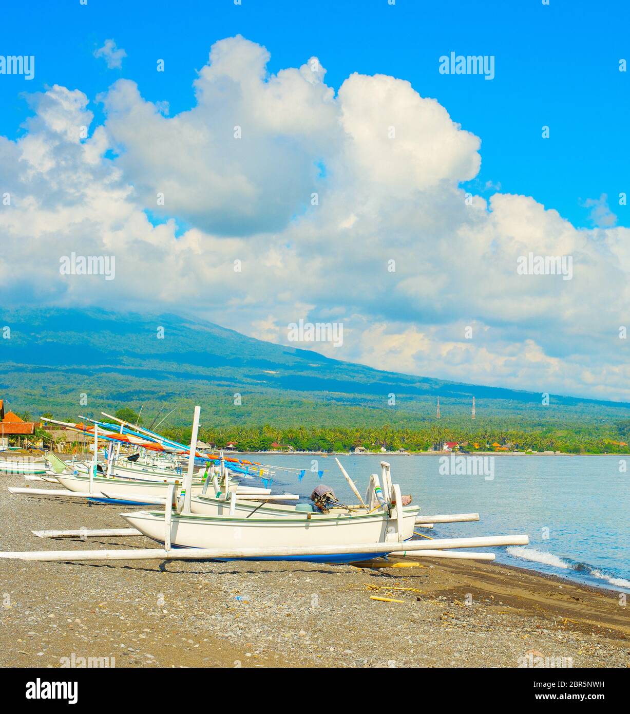 Sunshine weather at beach with traditional fishing boats, Agung volcano ...