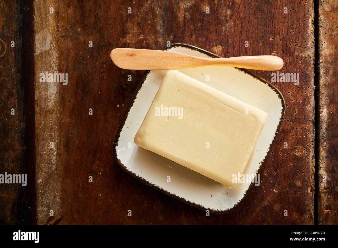 Whole pat of farm fresh creamy butter on a small rectangular butter ...