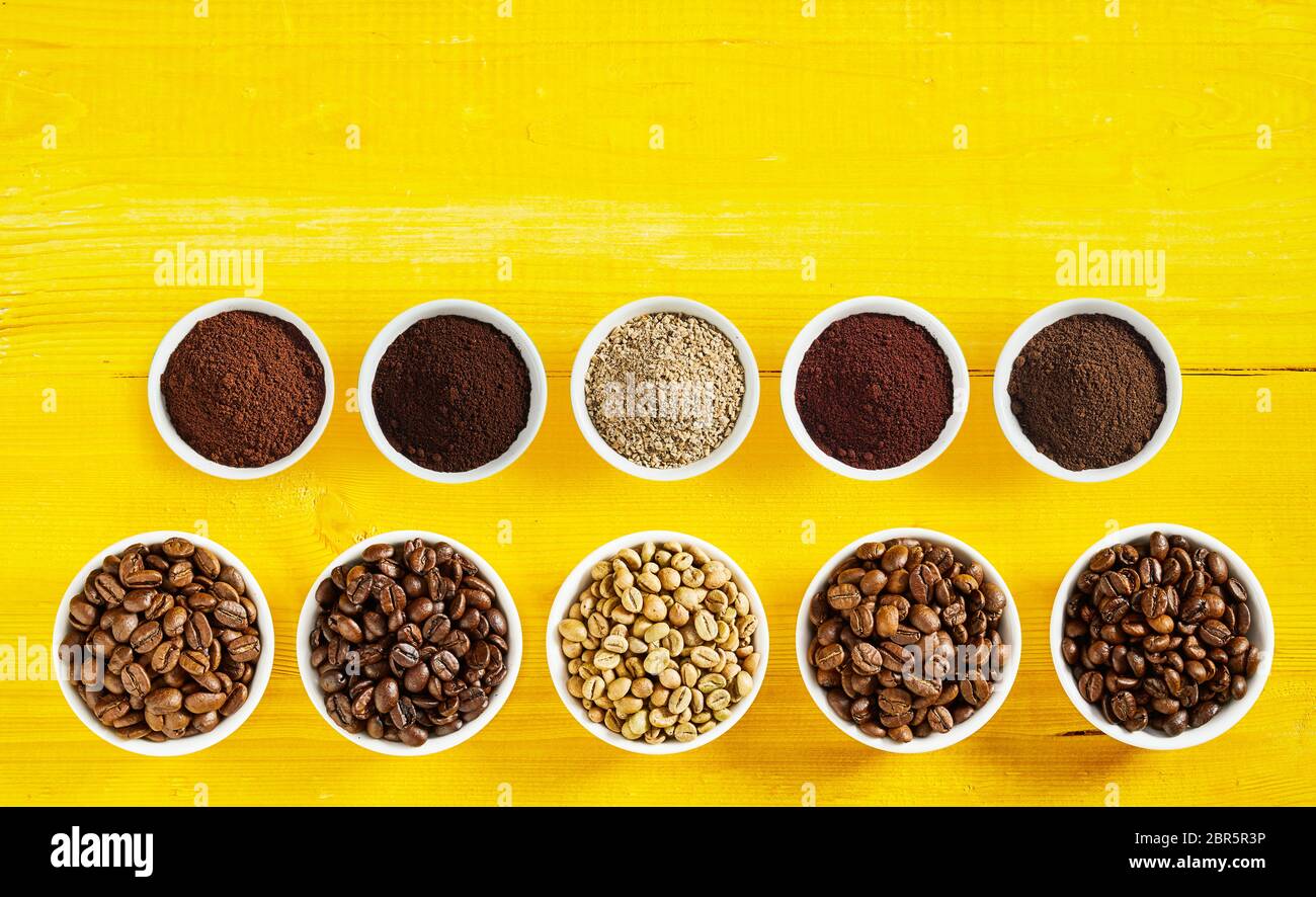 Assortment of roasted and raw coffee beans with matching grounds in ...