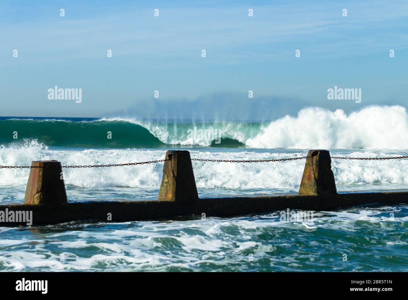 Ocean wave crashing front of swimming tidal pool Stock Photo - Alamy