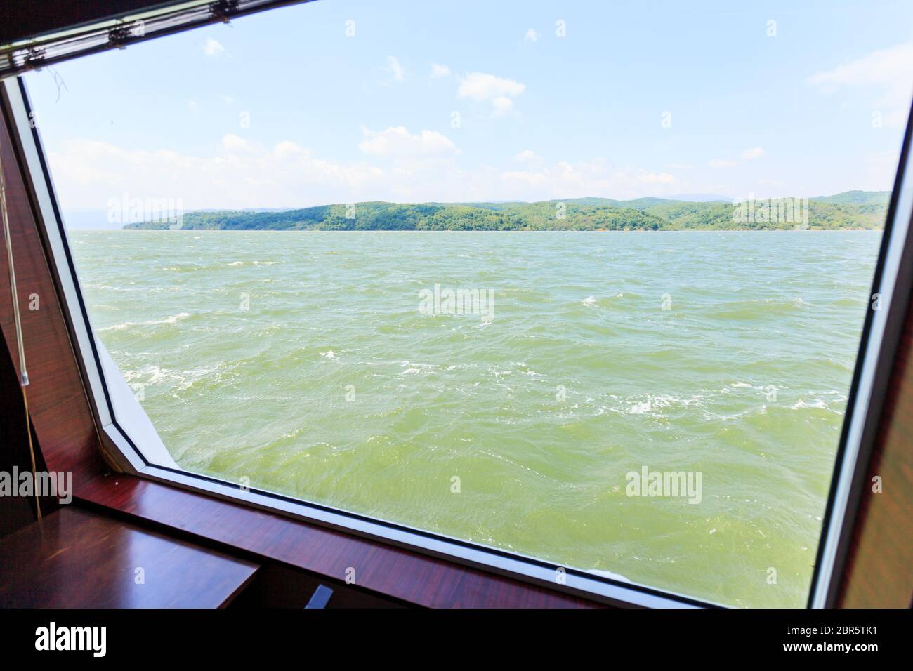 View of Danube river landscape through cruise ship window Stock Photo ...