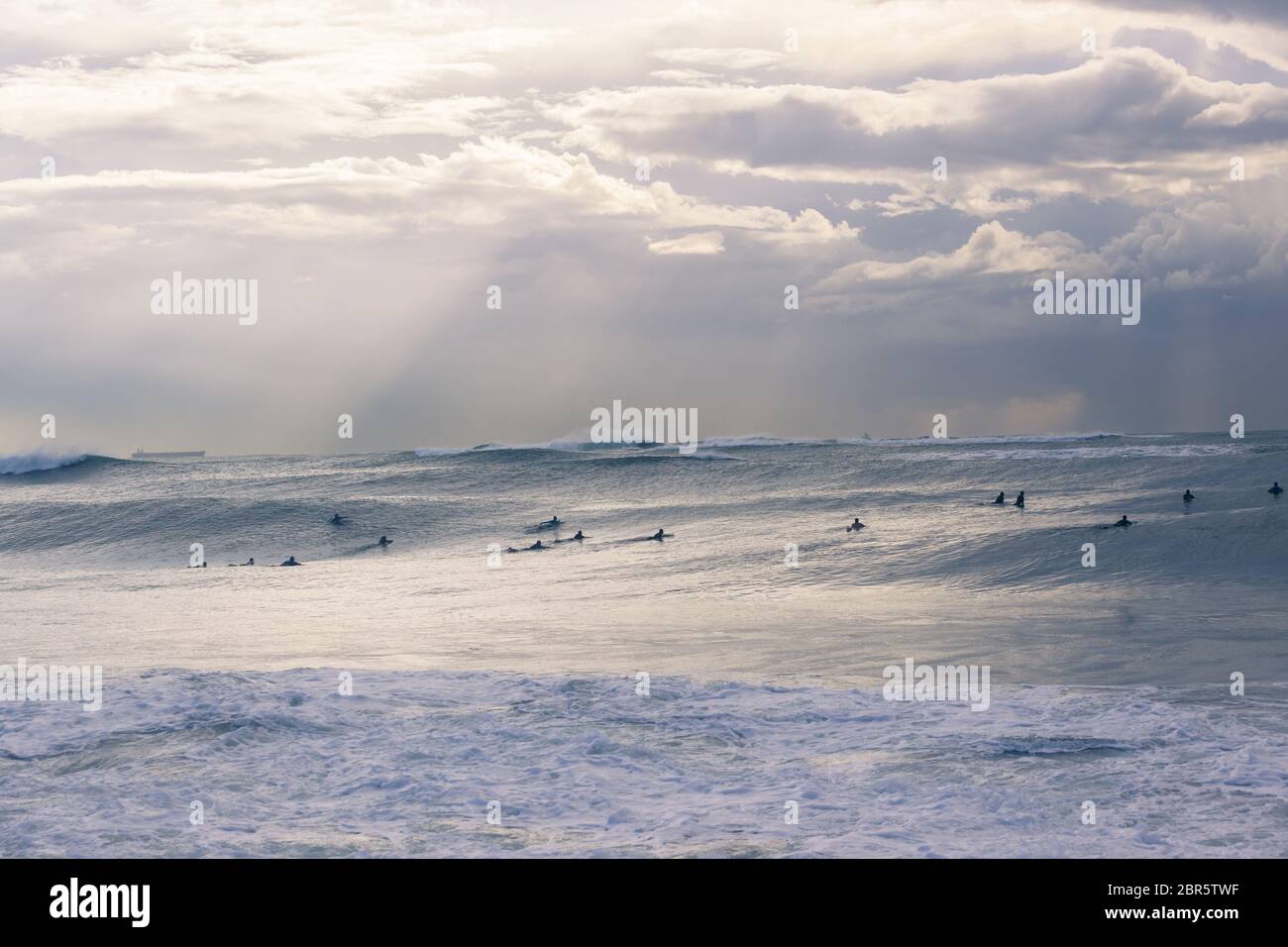 Surfers surfing ocean storm large waves Stock Photo - Alamy