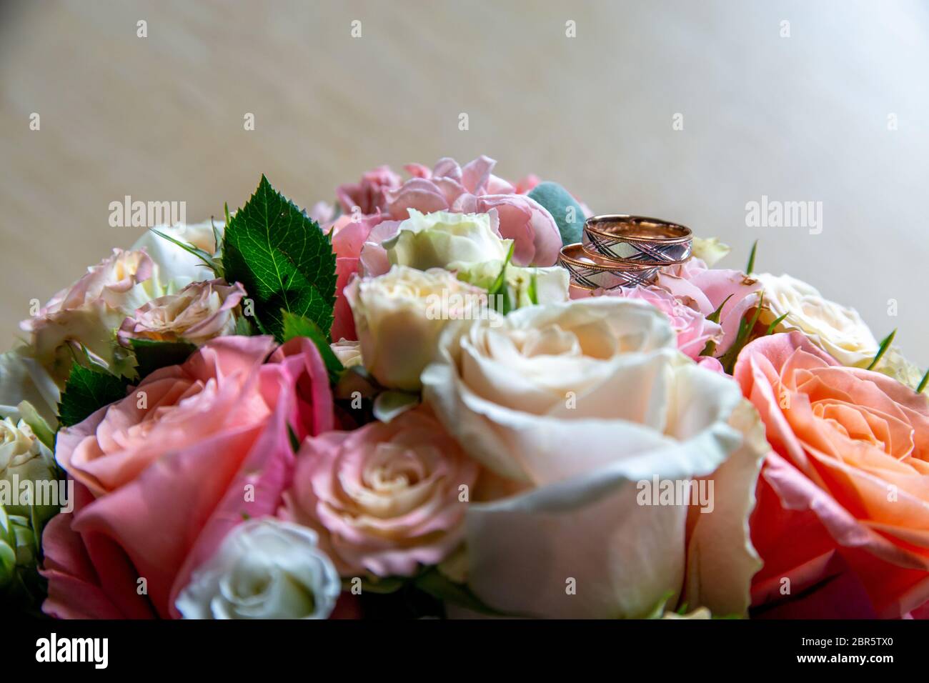 Wedding rings on the bouquet of roses. Wedding rings on bridal bouquet ...