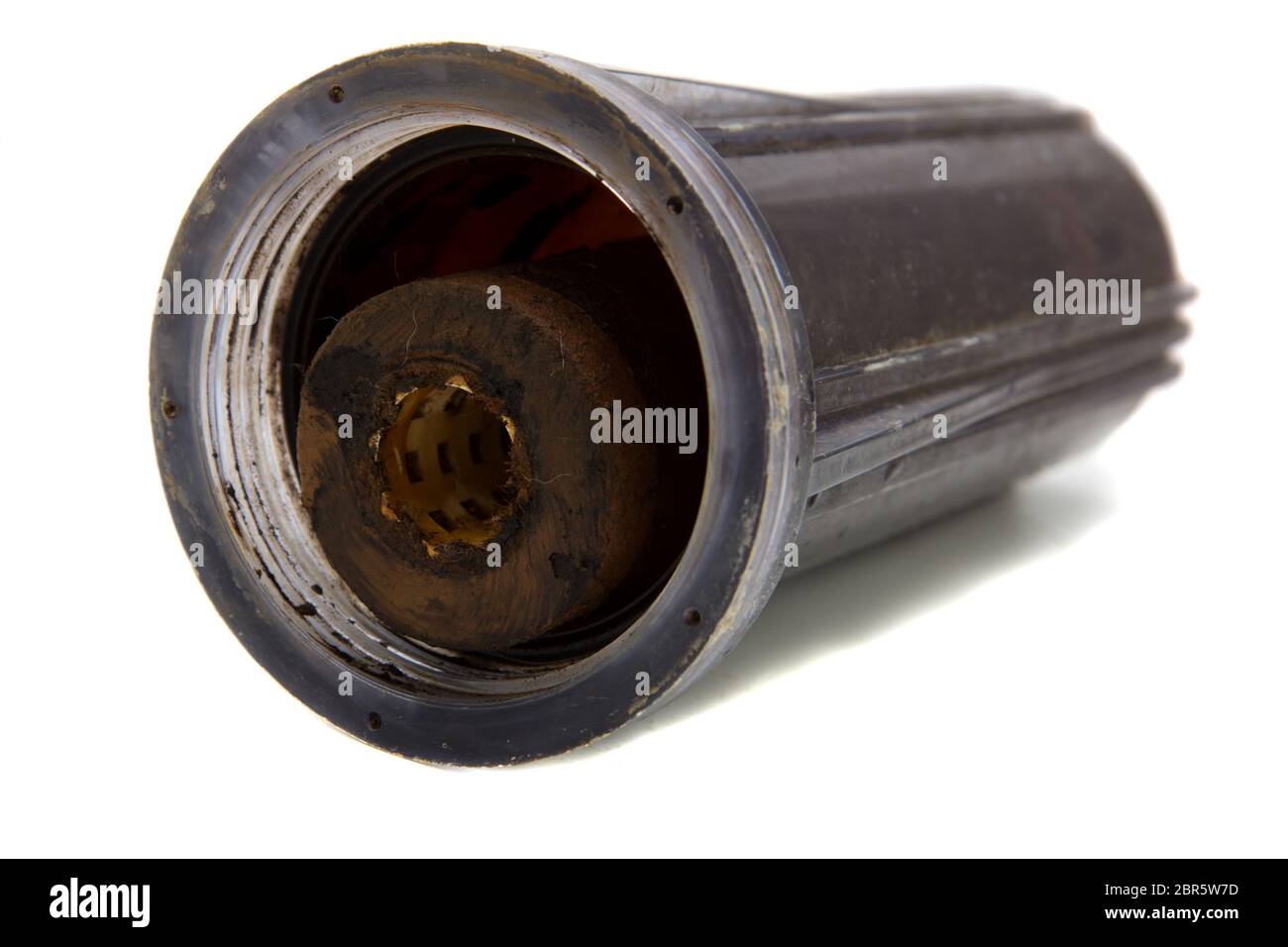 Old dirty water filter in plastic holder isolated on white background ...