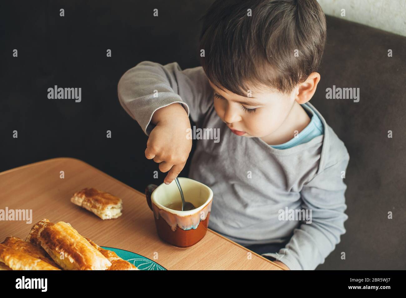 Cute boy drinking tea hi-res stock photography and images - Alamy