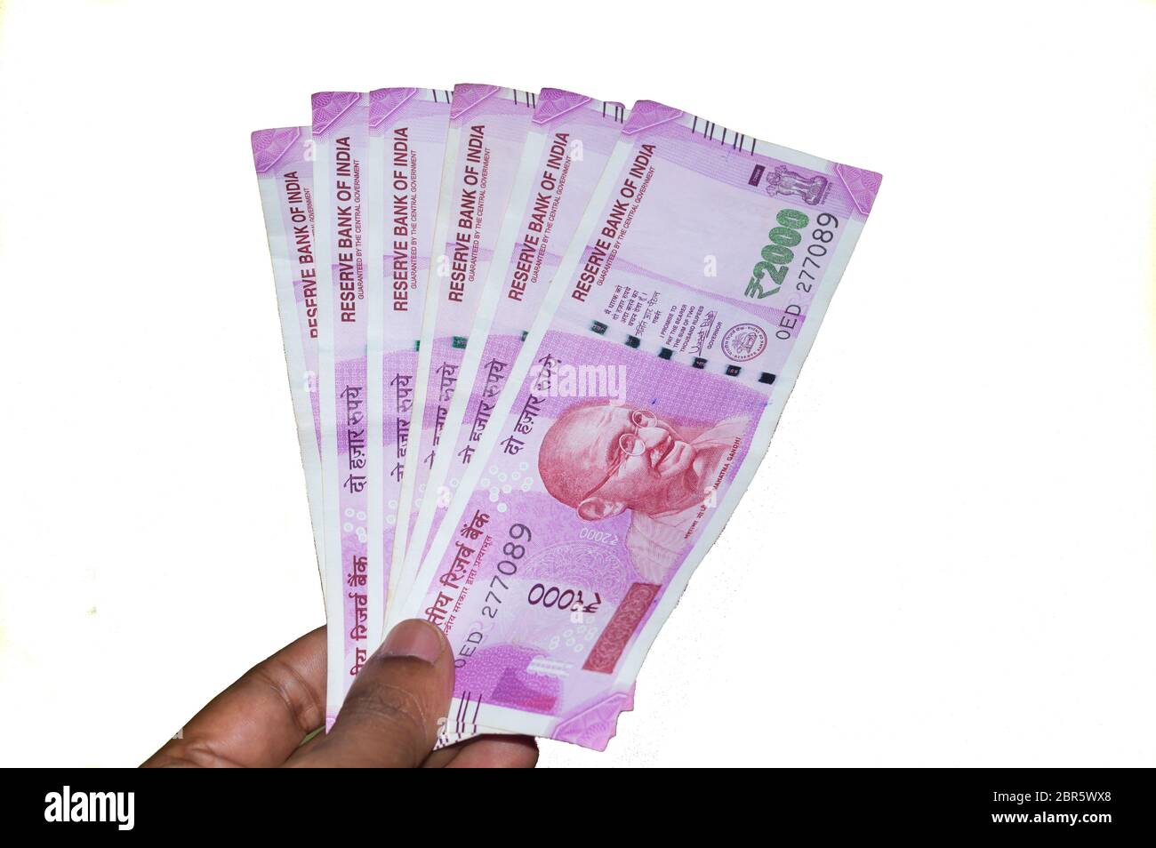 Hand holding indian rupee notes hi-res stock photography and images - Alamy