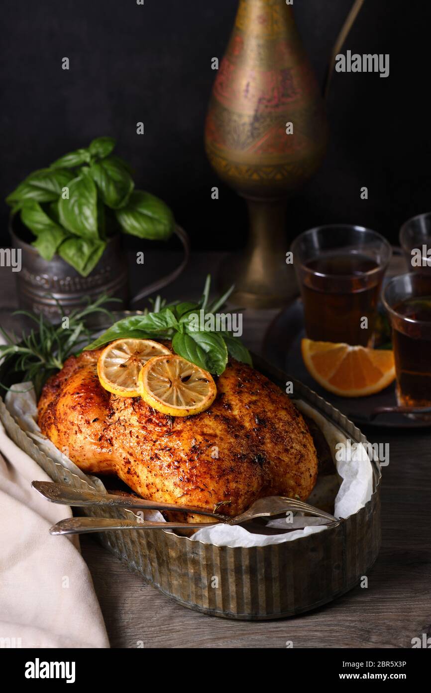Baked whole chicken in spices with crispy appetizing fried crust in a ...