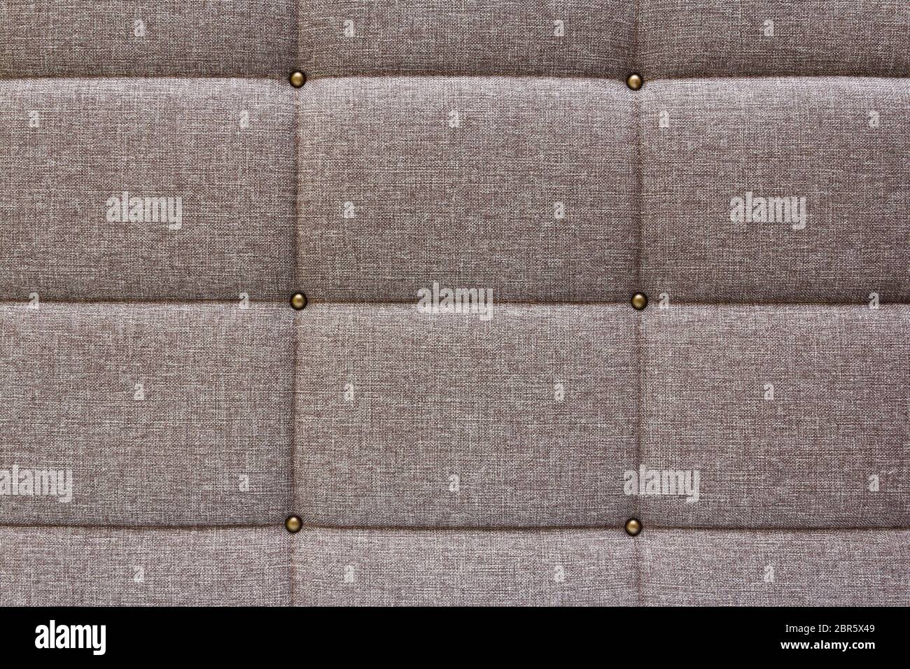 Brown fabric texture closeup with decorative stitching from threads ...