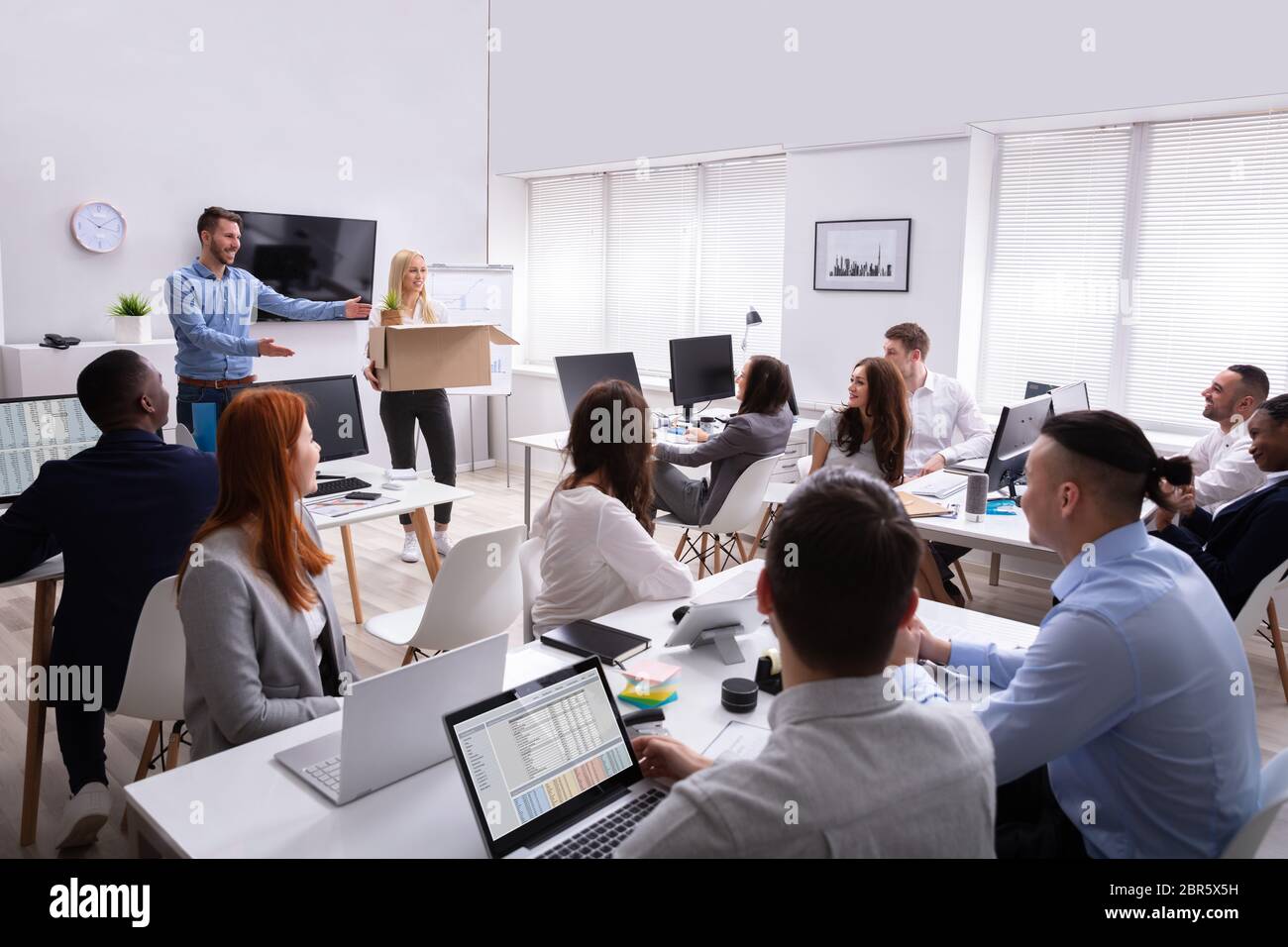 Smiling Young Manager Welcoming New Female Employee Introducing Her To ...