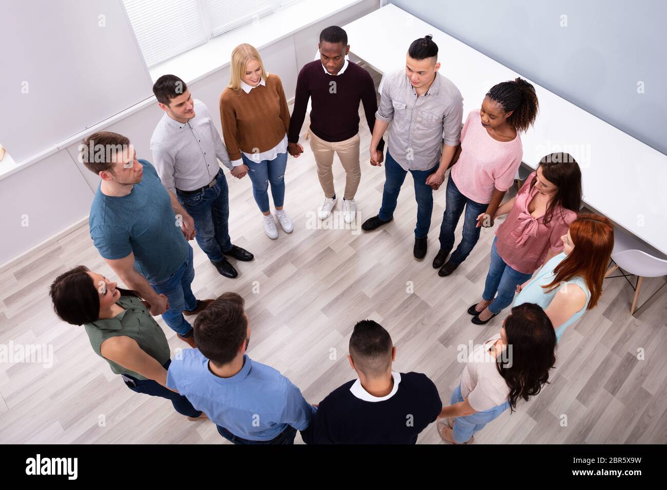Group Of Multi-ethnic People Standing In Circle Holding Each Other ...
