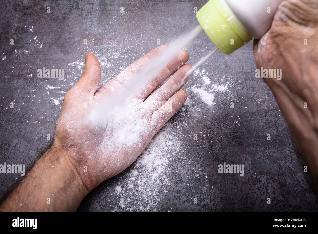 Close-up Of Man's Hand Using Talcum Powder Over Black Background Stock ...