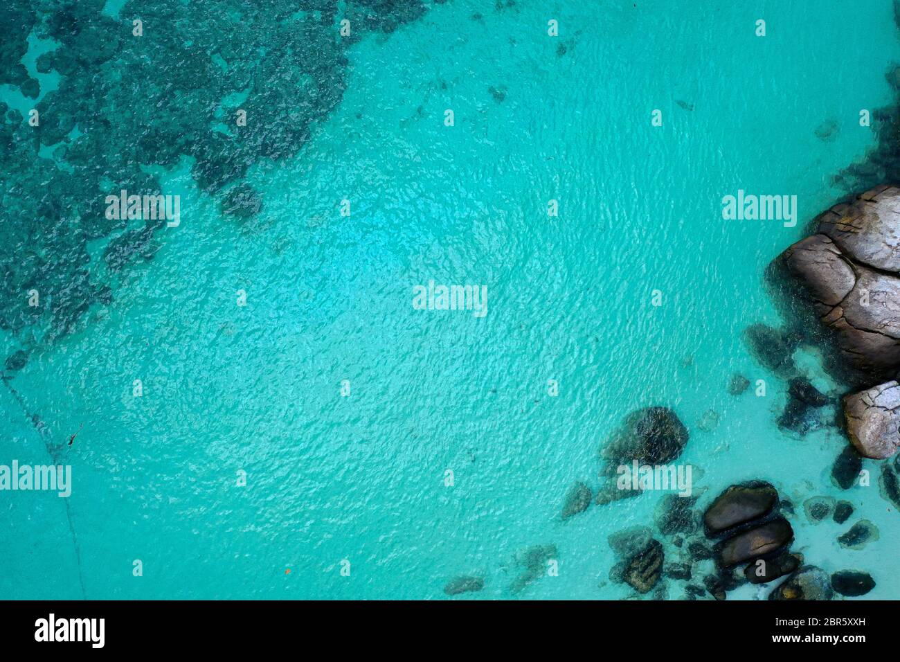 Aerial drone top view of crystal clear lagoon sea water surface with ...