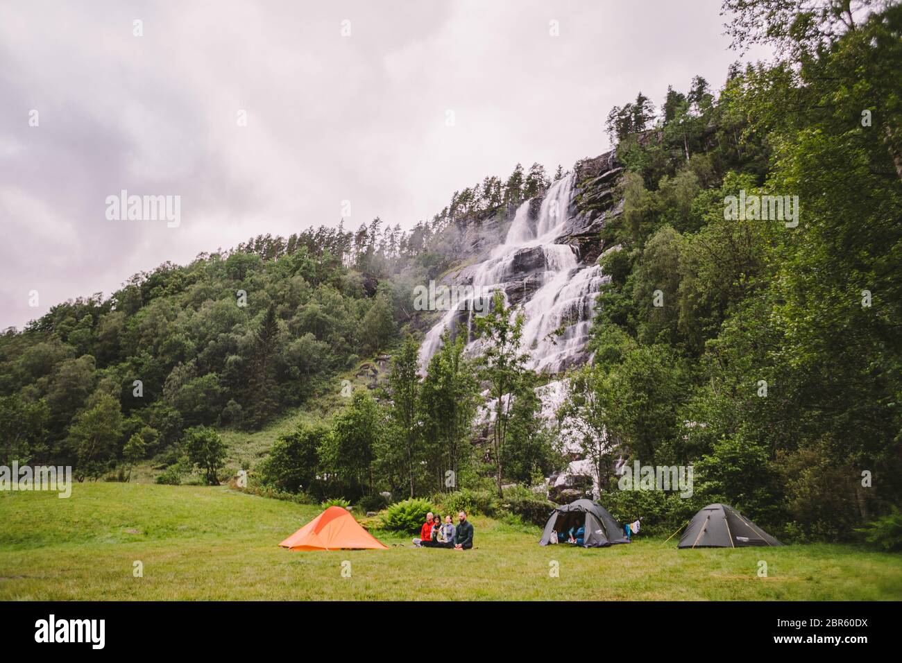 Tvinde Camping tents on the background of a waterfall Tvindefossen in ...