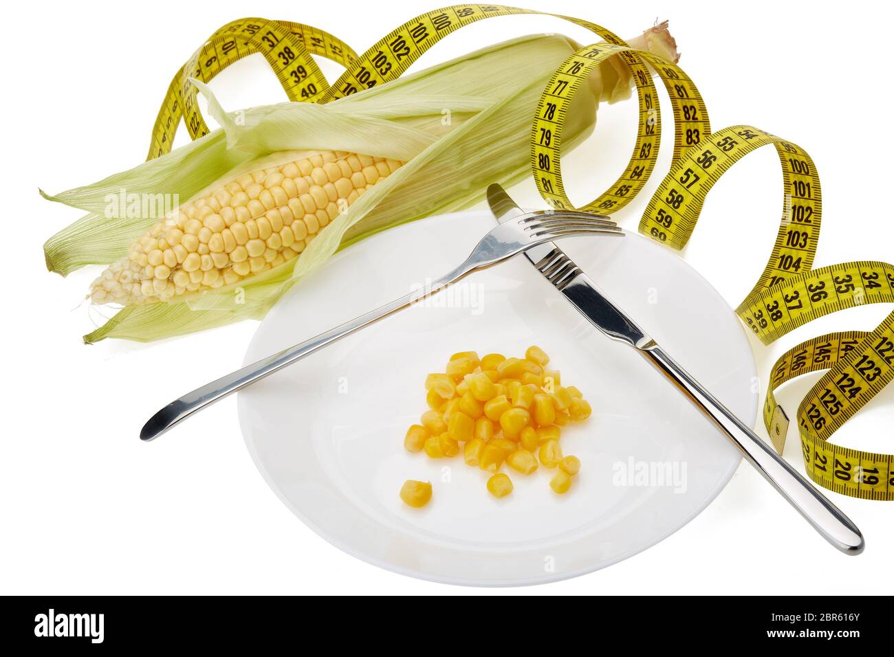 Fresh ripe ear of corn, plate with boiled corn kernels and measuring ...
