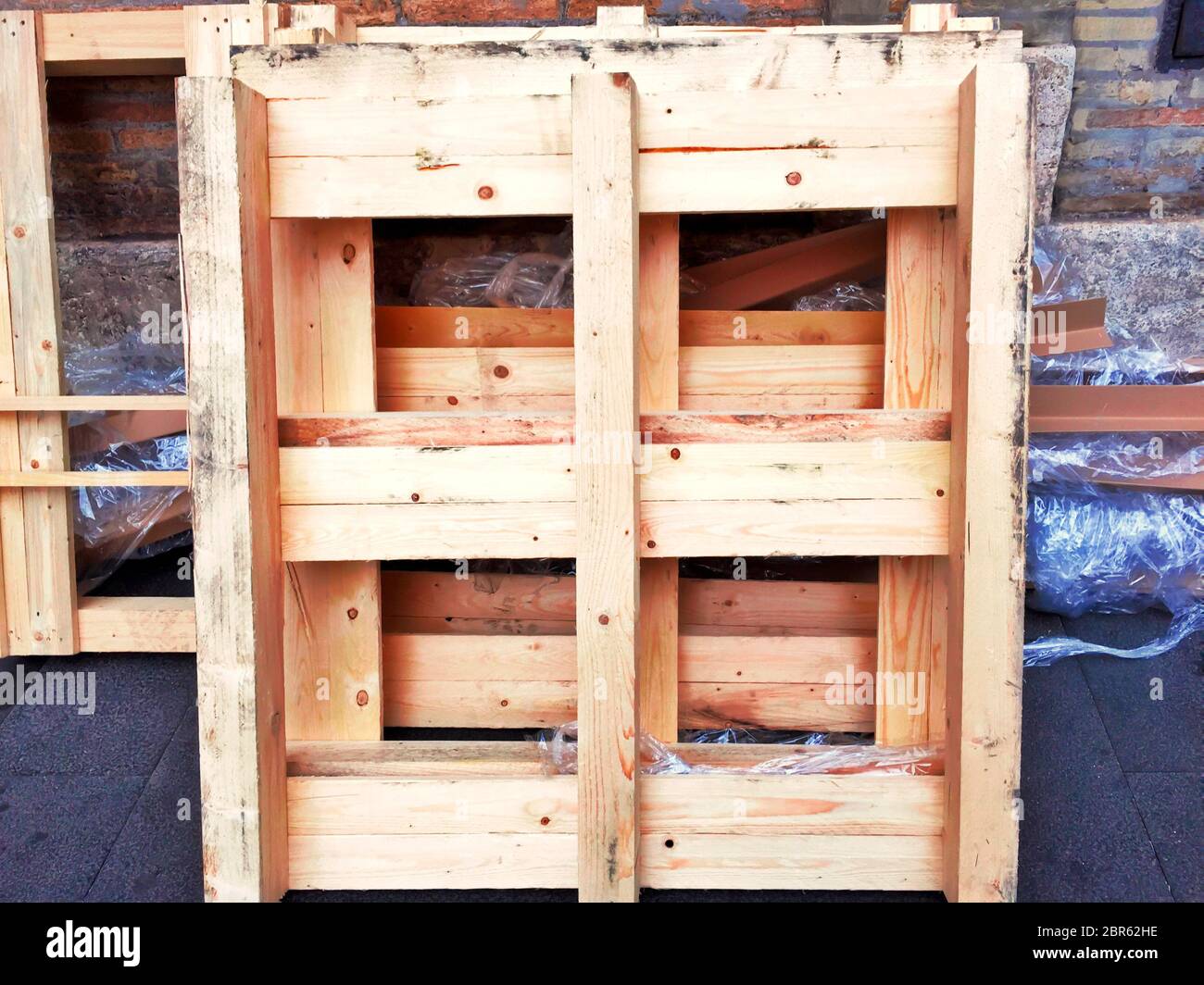 Dirty wooden pallets left on the wall. Construction and industrial ...