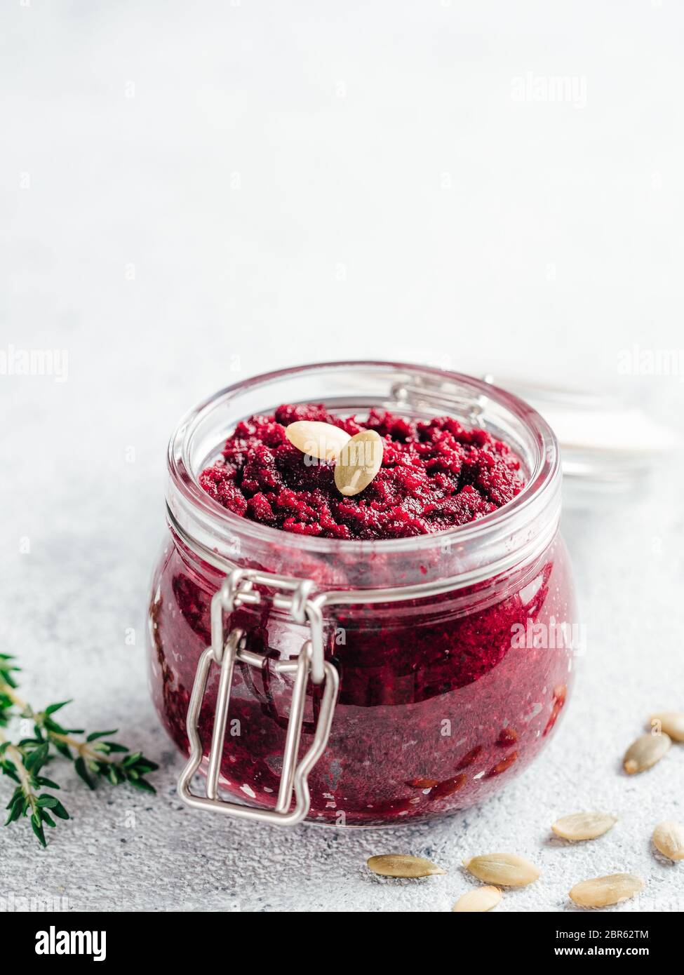 Beetroot pesto or hummus. Homemade beet pesto sauce in glass jar and ...
