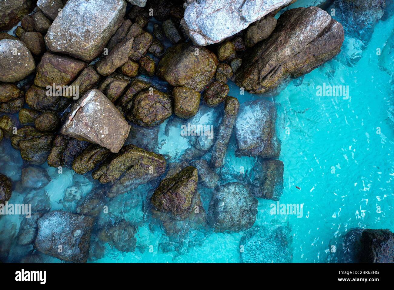 Aerial drone top view of crystal clear lagoon sea water surface with ...