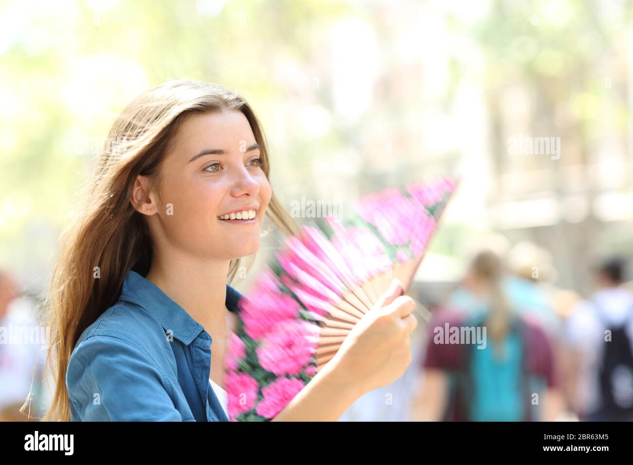 Woman walking outside summer high street hi-res stock photography and ...