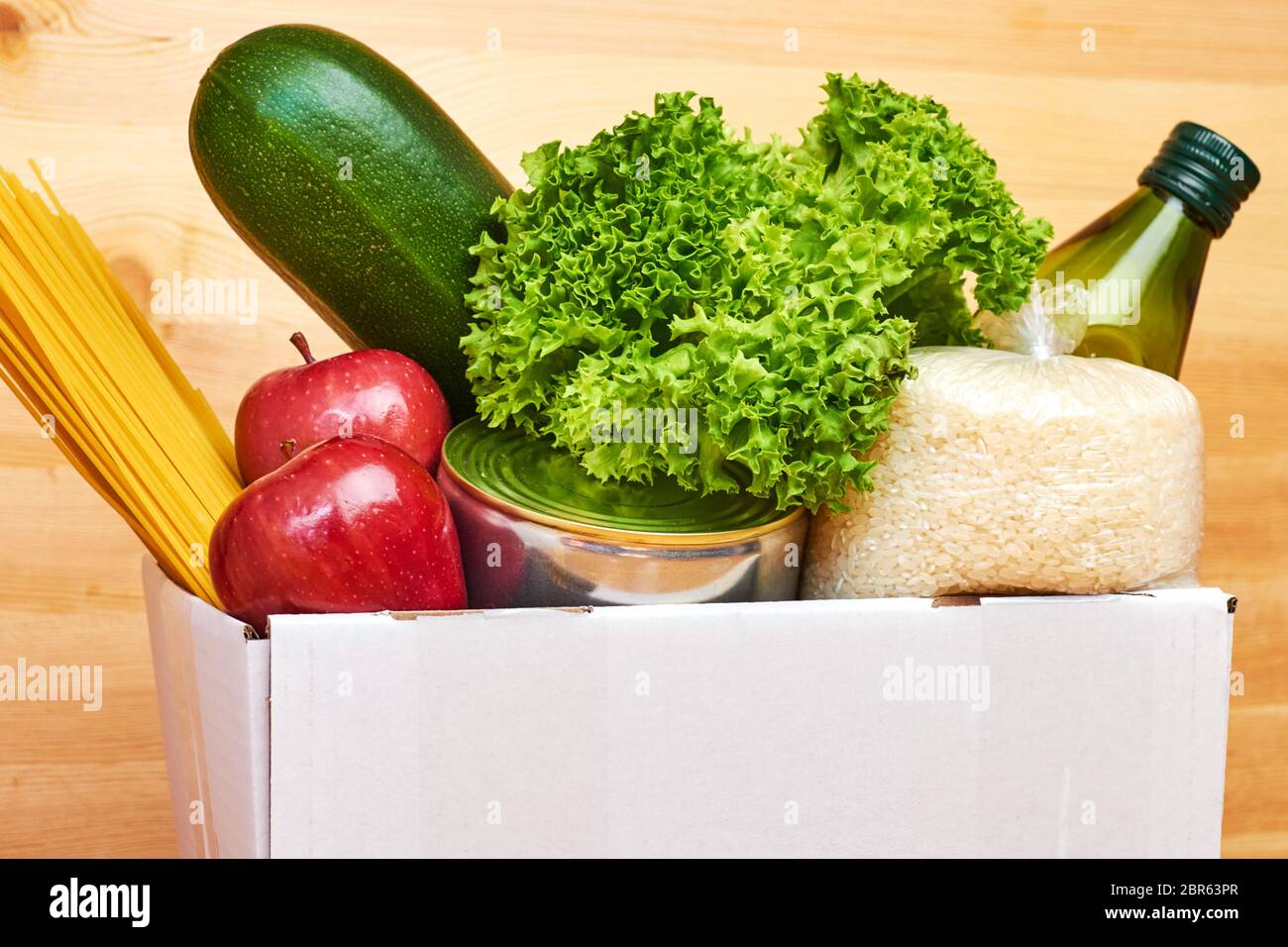 Close up white box with different healthy products on a wooden ...