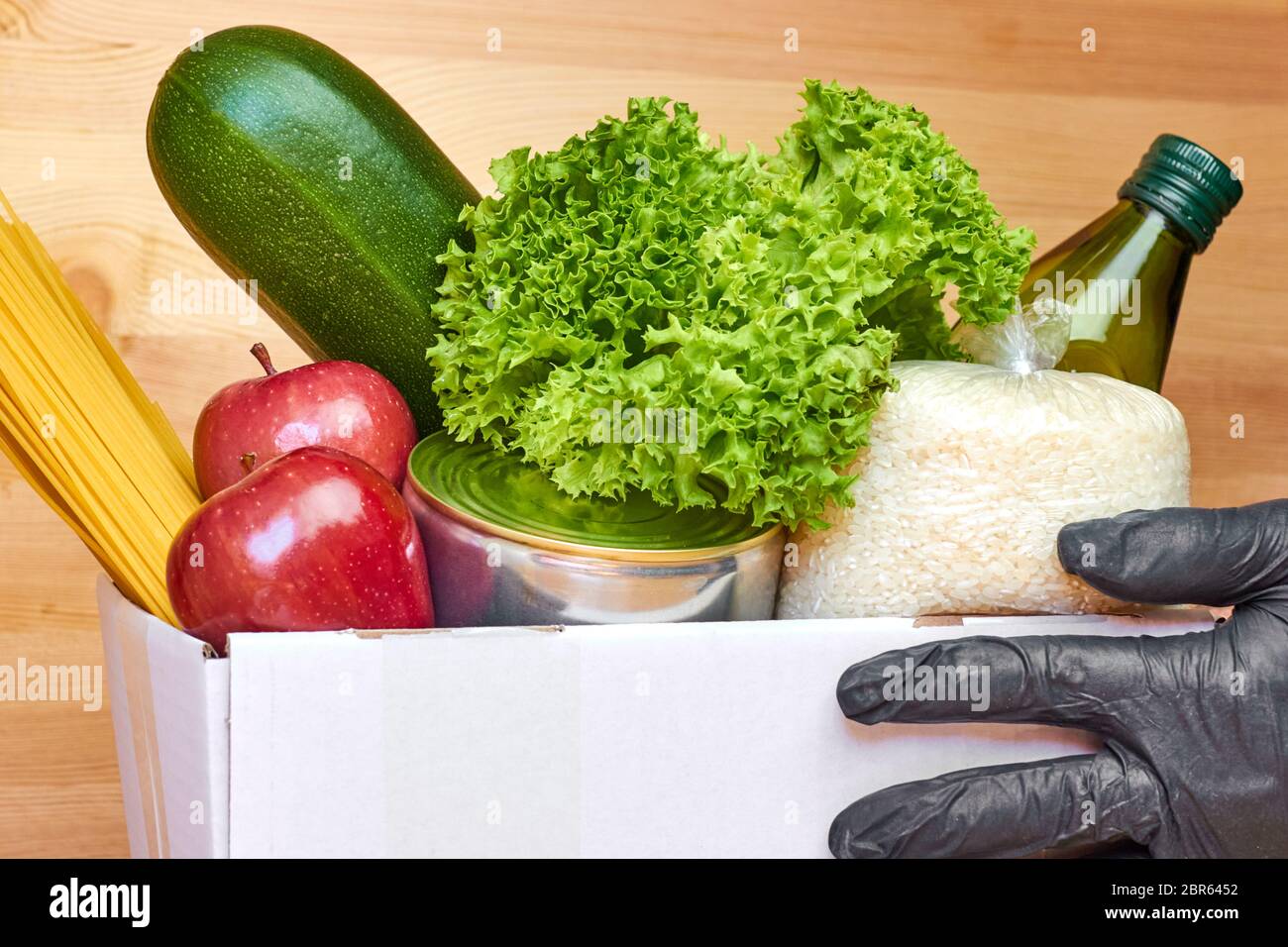 Close up mans hand holding a box with healthy and fresh product. Safety ...