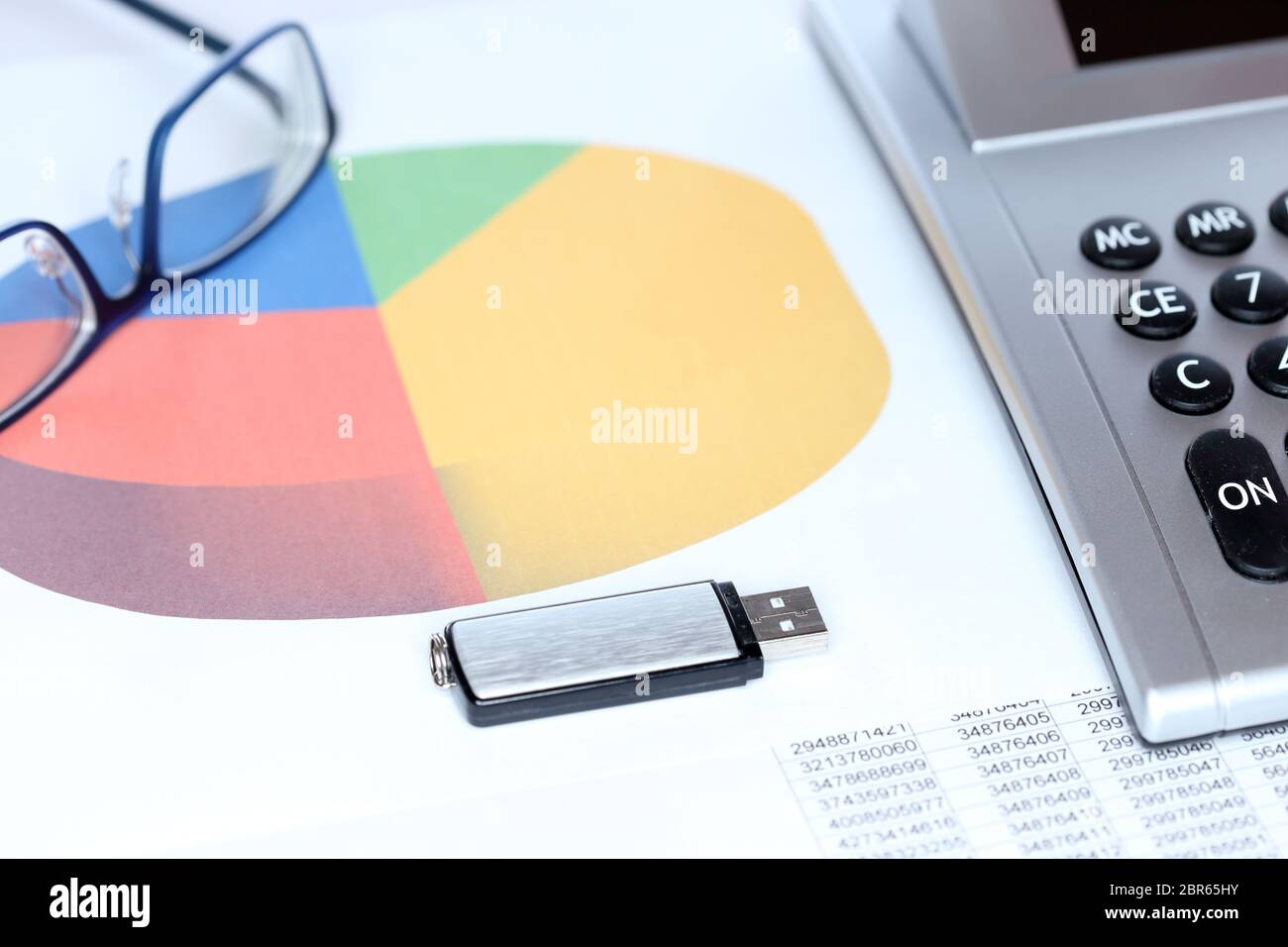 data- disk with glasses and calculator on a desk Stock Photo - Alamy