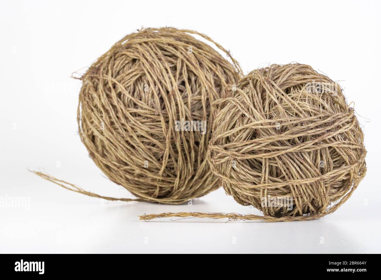 Two balls of coiled string for gardening. Cord for tying plants. Light ...