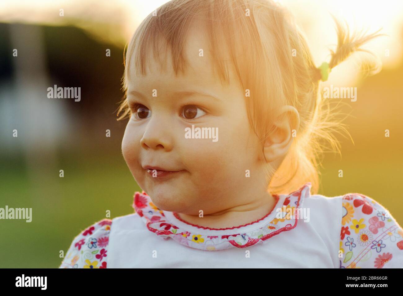 Baby portrait of adorable smiling caucasian baby girl outdoors at ...