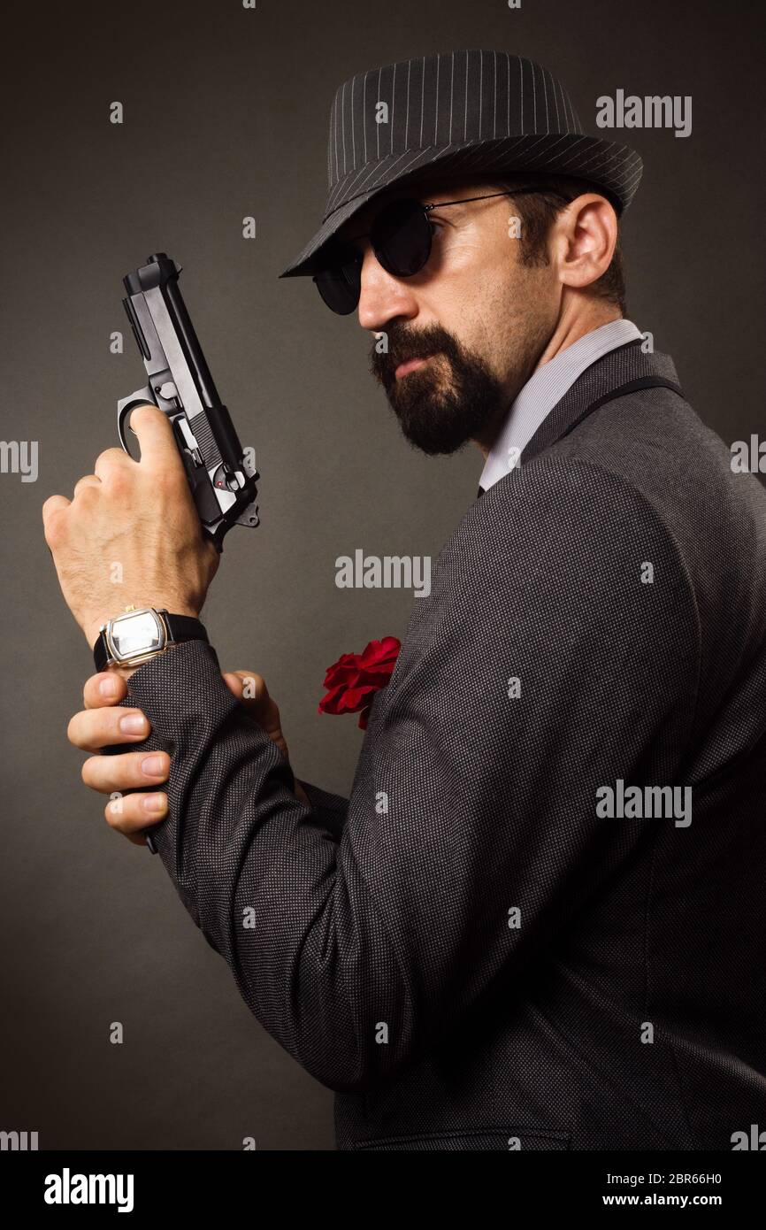 Man in a suit with a gun in his hand hi-res stock photography and ...