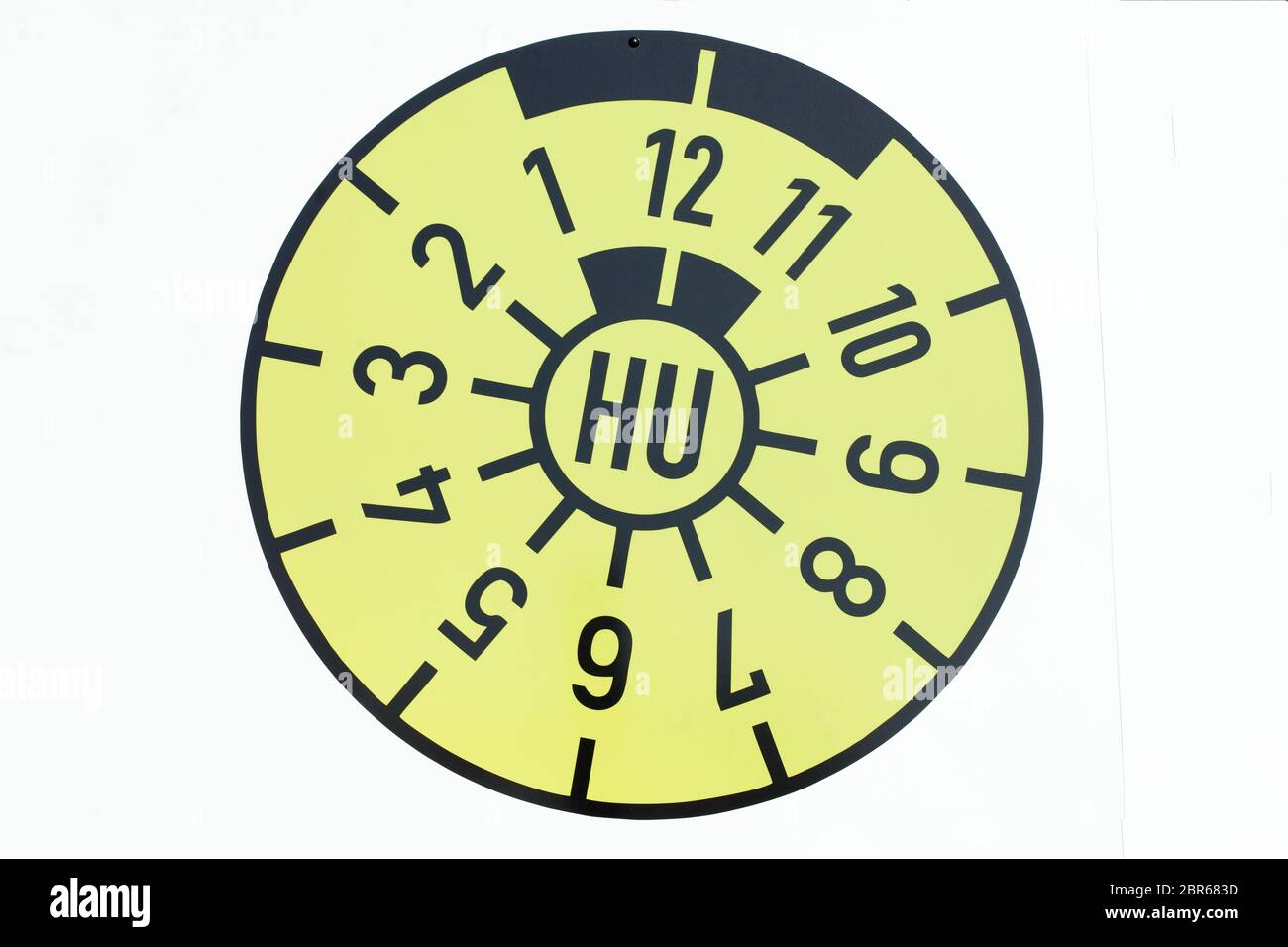 Greenish yellow TÜV sticker Stock Photo - Alamy