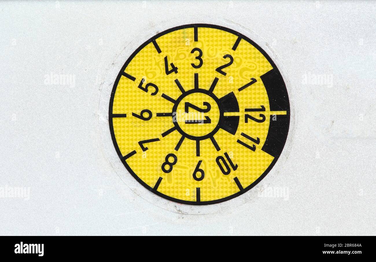 Yellow TÜV sticker, white background, Germany Stock Photo - Alamy