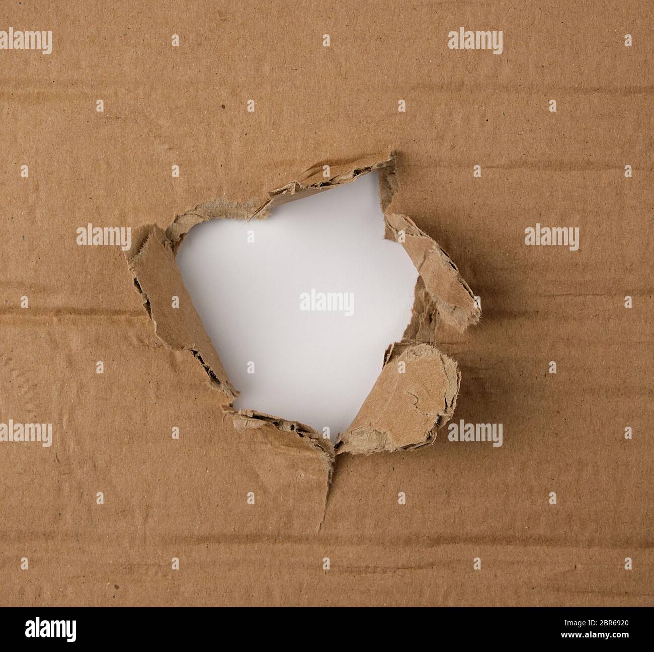 brown sheet of paper with a hole, full frame, white inside Stock Photo ...