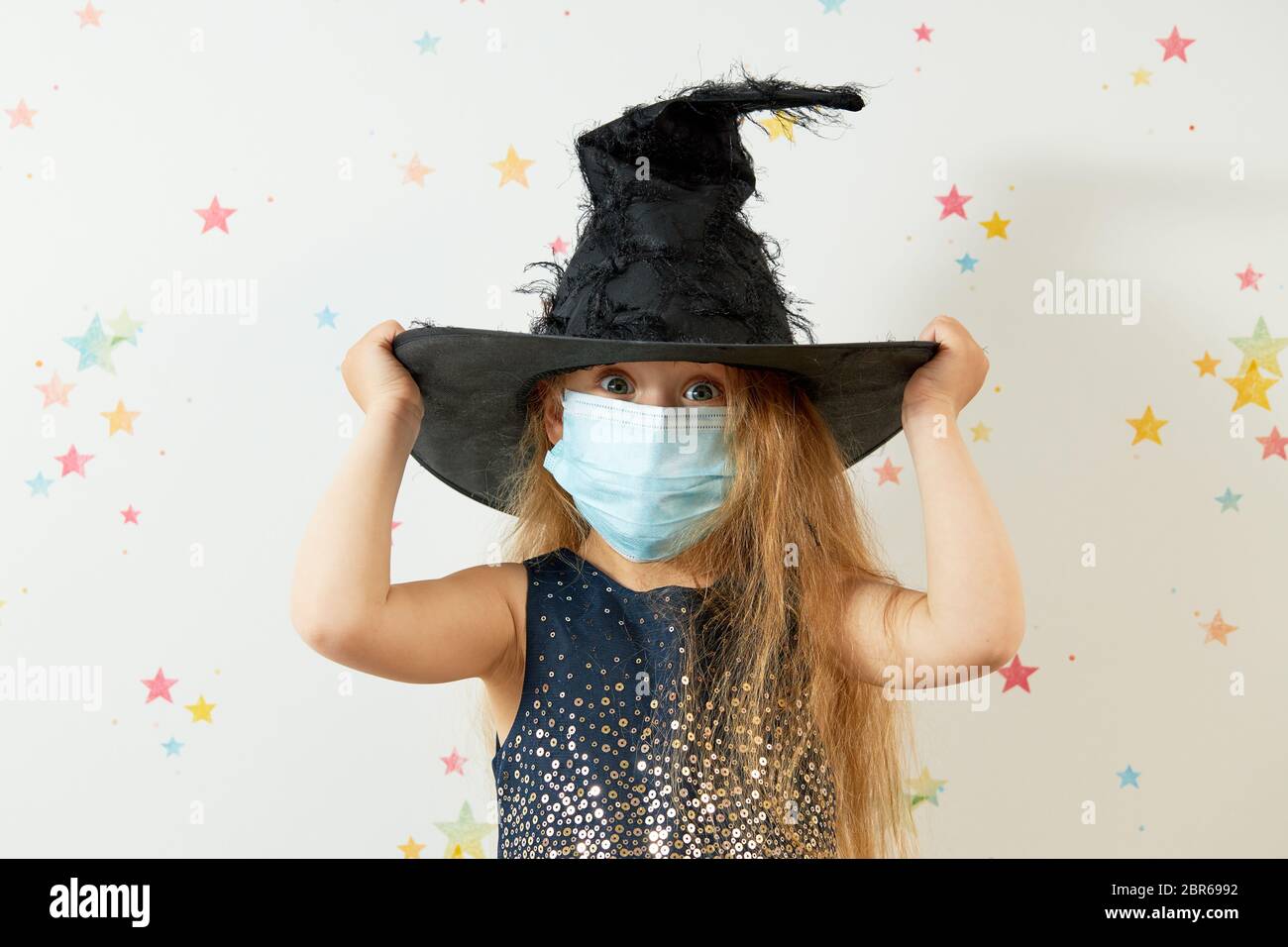 Happy Halloween on quarantine coronavirus pandemic. Little girl child ...
