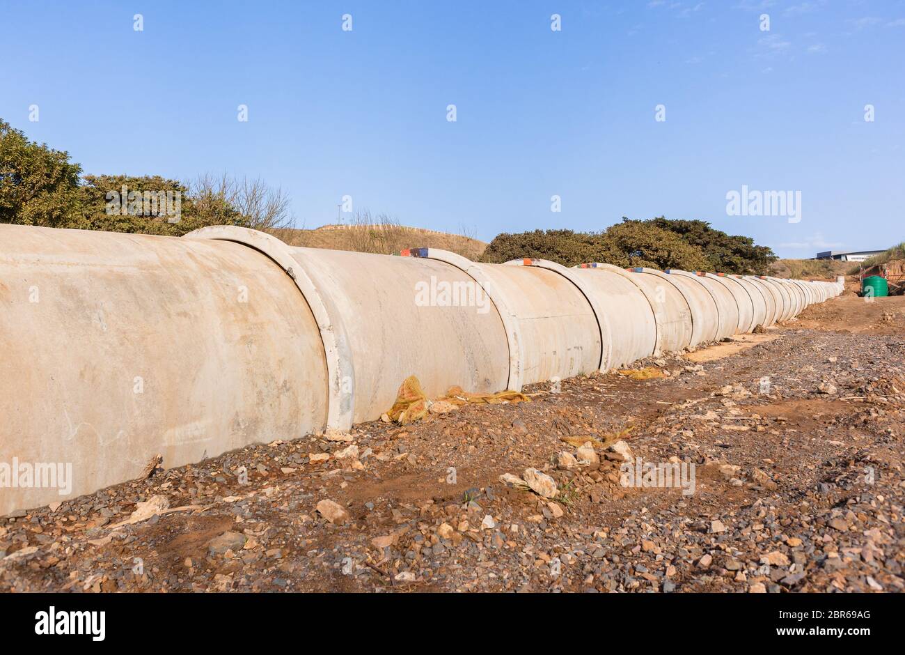 New concrete pipeline for waste water through countryside landscape ...