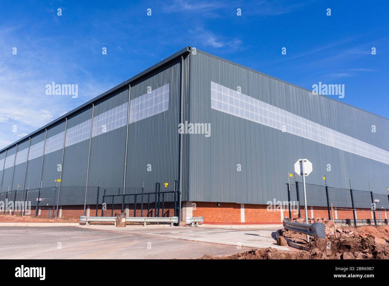 New large warehouse industrial building structure in blue morning sky ...