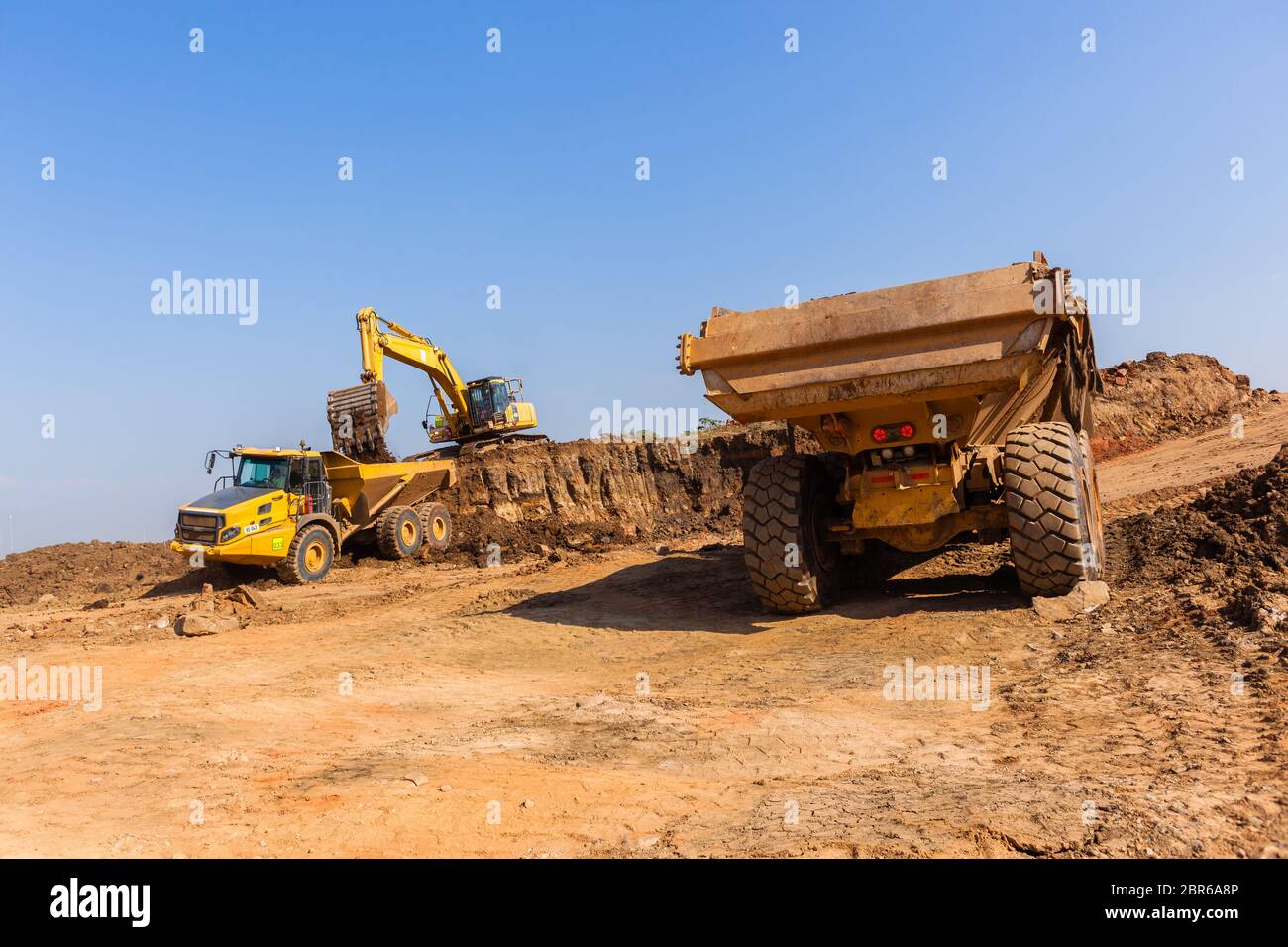 Construction industrial earthworks grader machine loading earth into ...