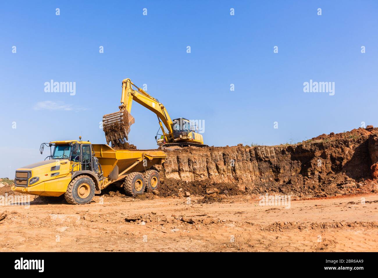 Construction industrial earthworks grader machine loading earth into ...
