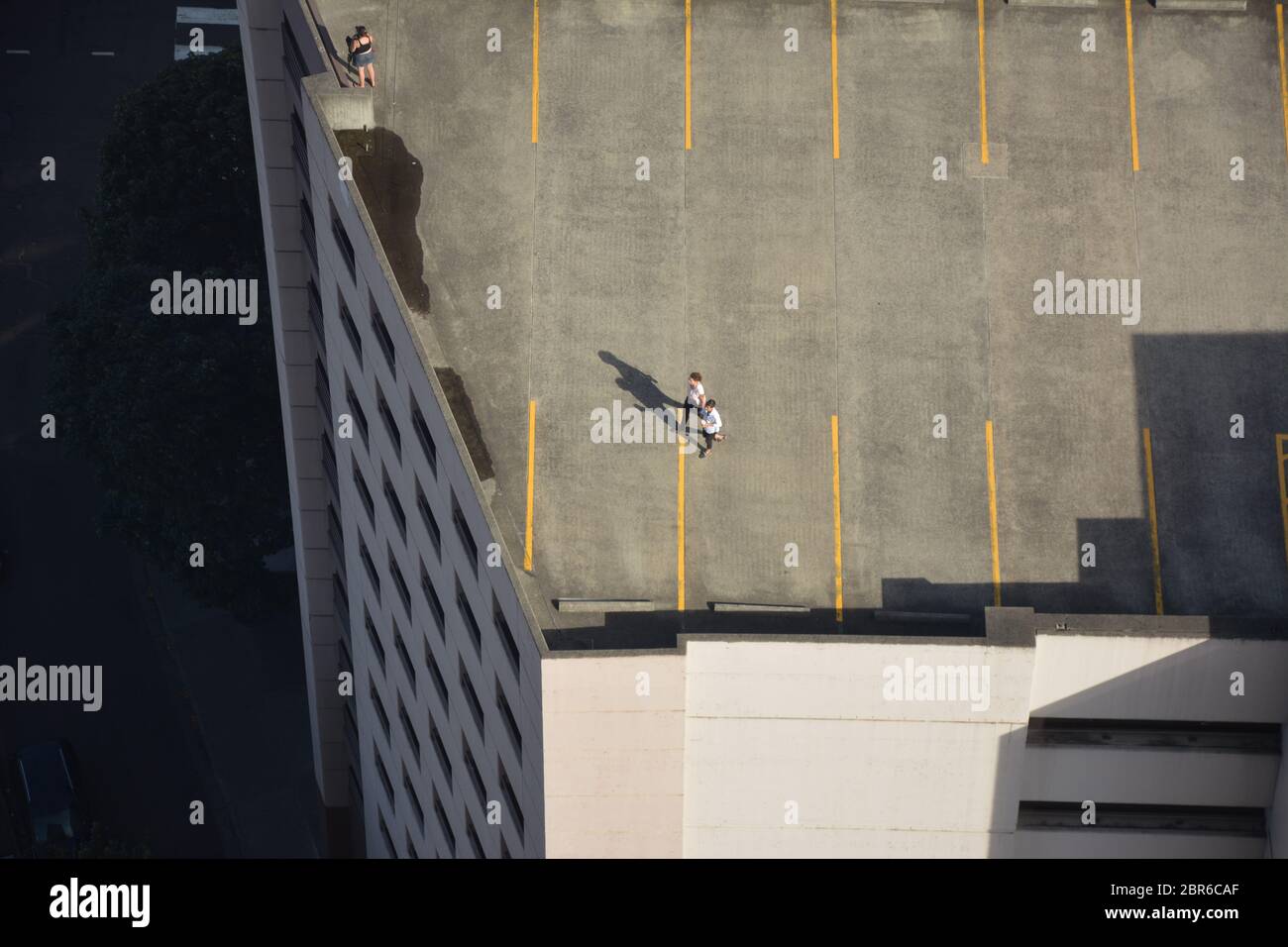 Aerial view of people on the open rooftop of a parking garage in ...