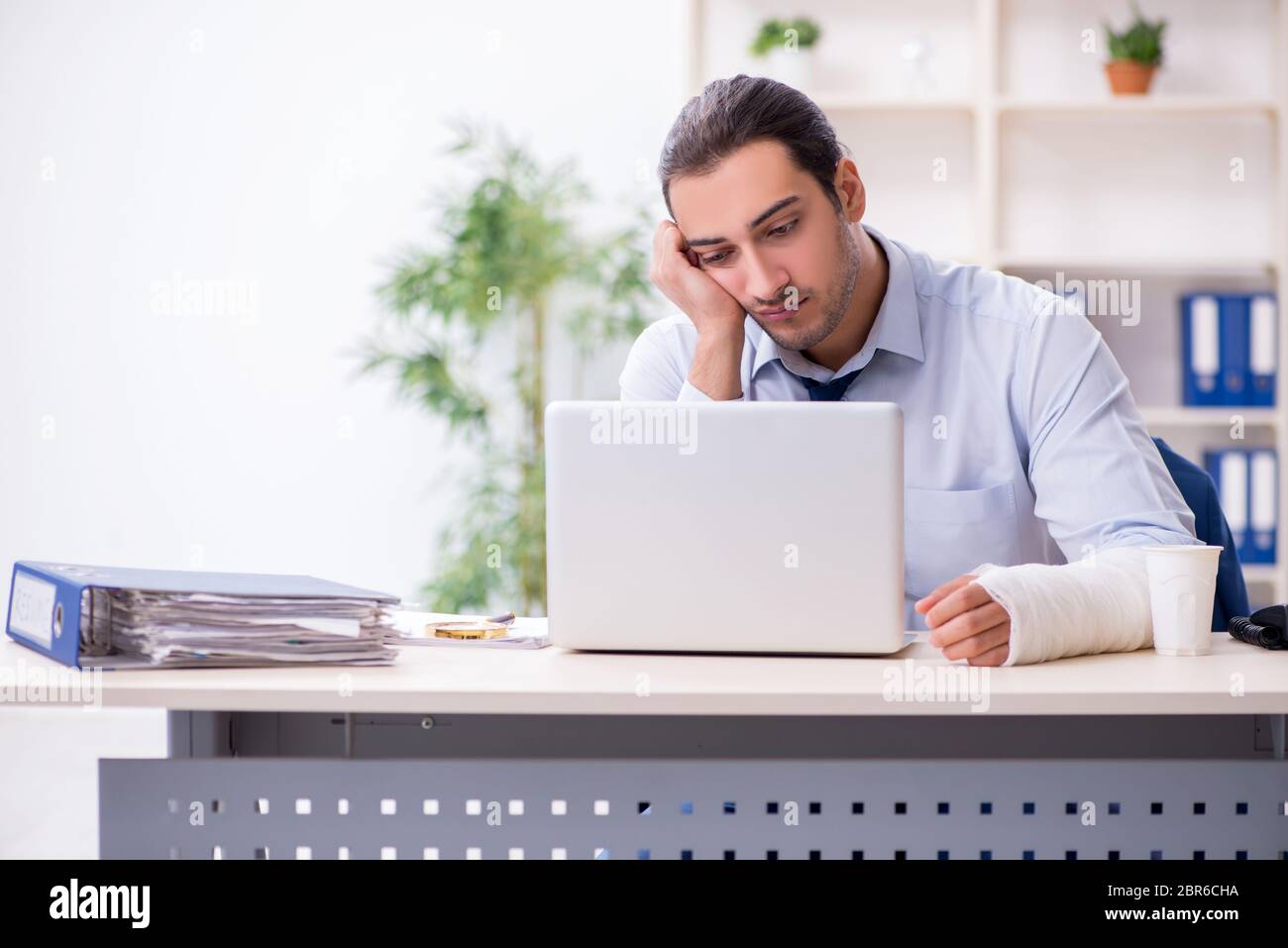 Injured male employee at work after accident Stock Photo - Alamy