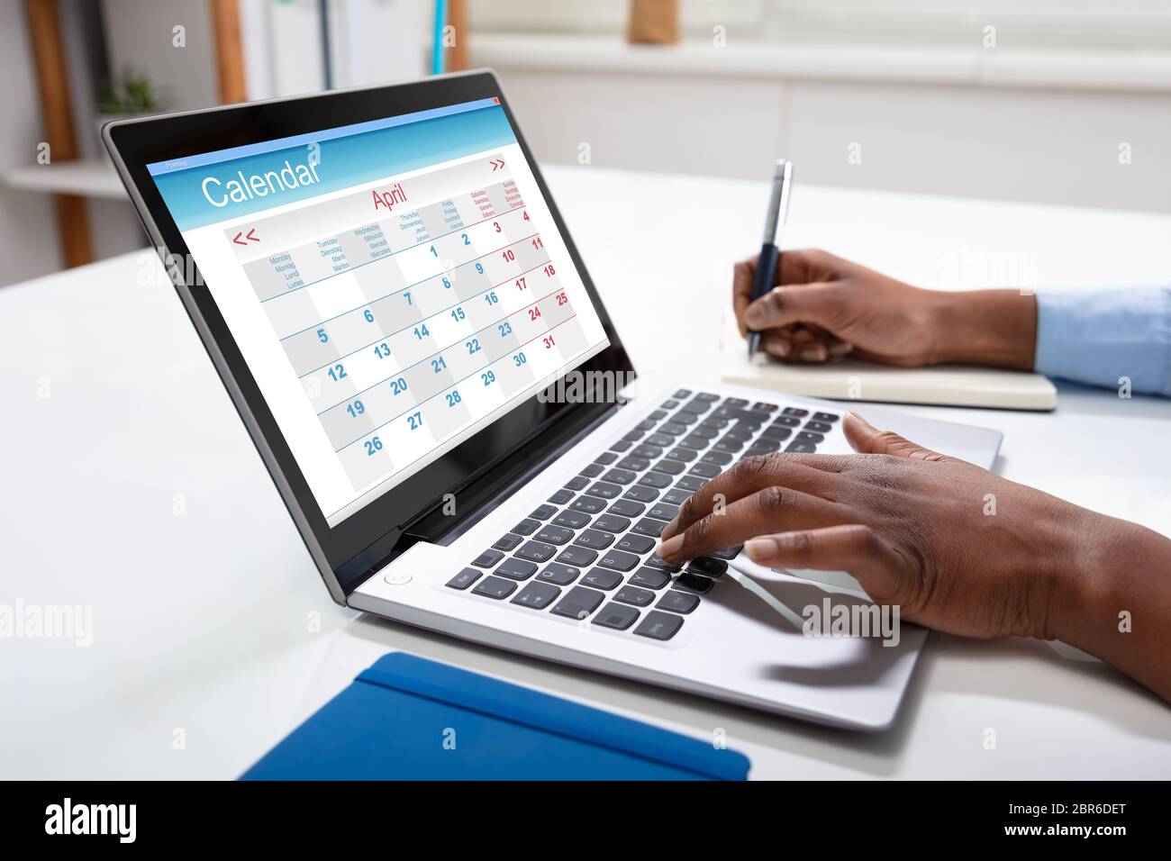 Woman looking at calendar on desk hi-res stock photography and images ...