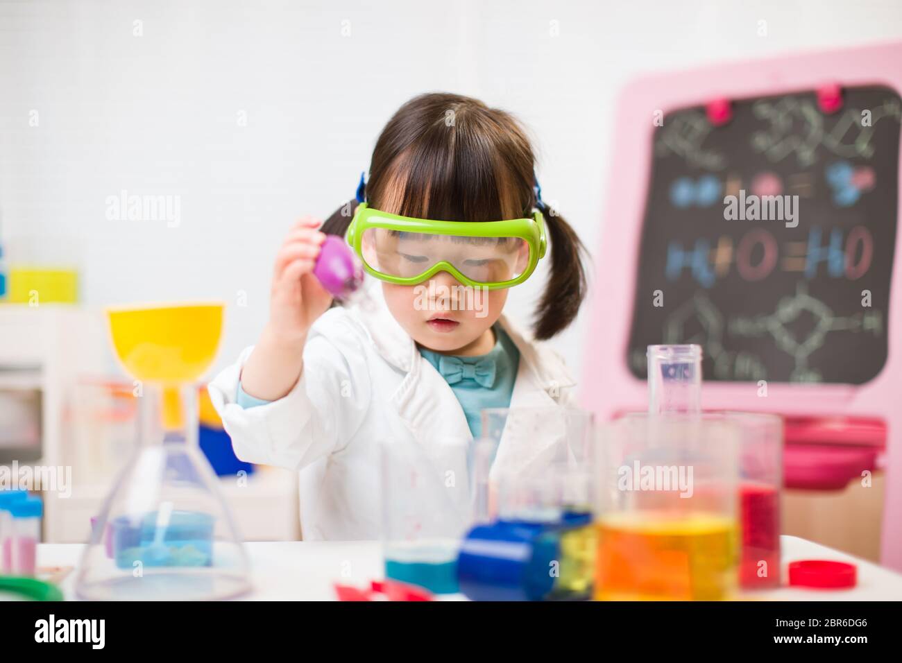 toddler girl pretend play scientist role for homeschooling Stock Photo ...