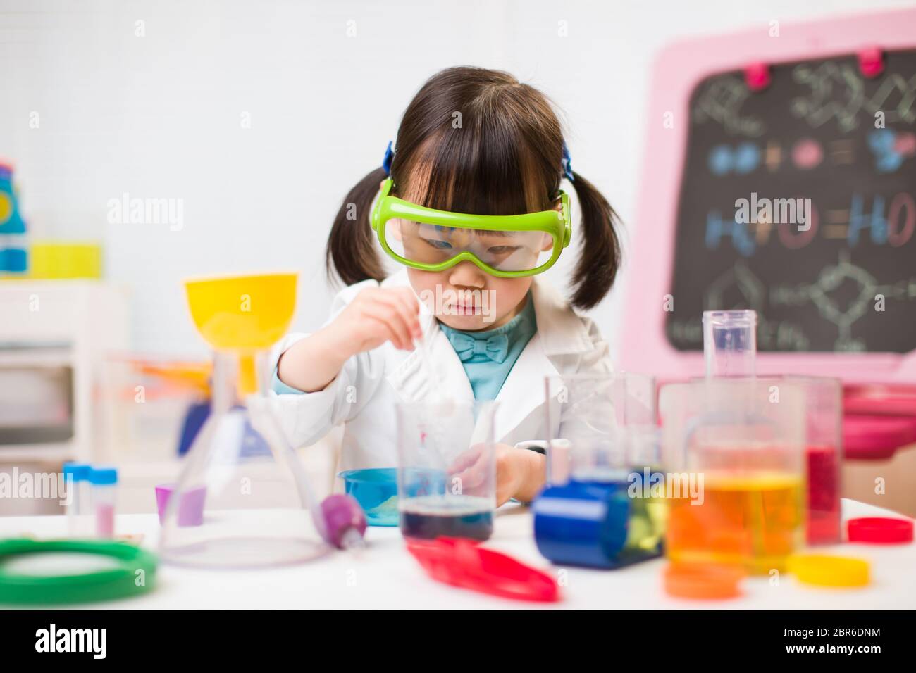 toddler girl pretend play scientist role for homeschooling Stock Photo ...