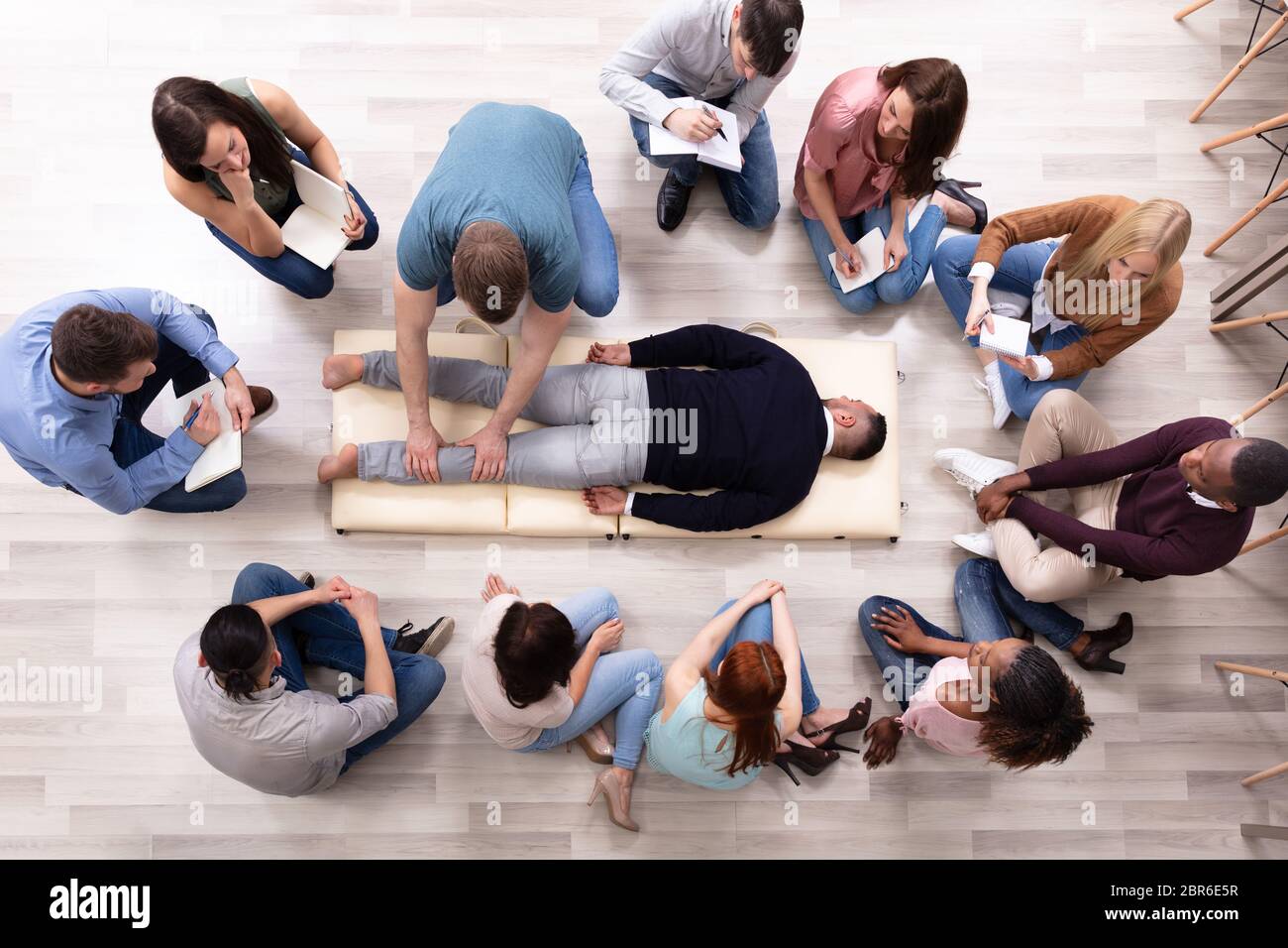 Group Of People Sitting In Circle Learning Massage Technique Stock ...