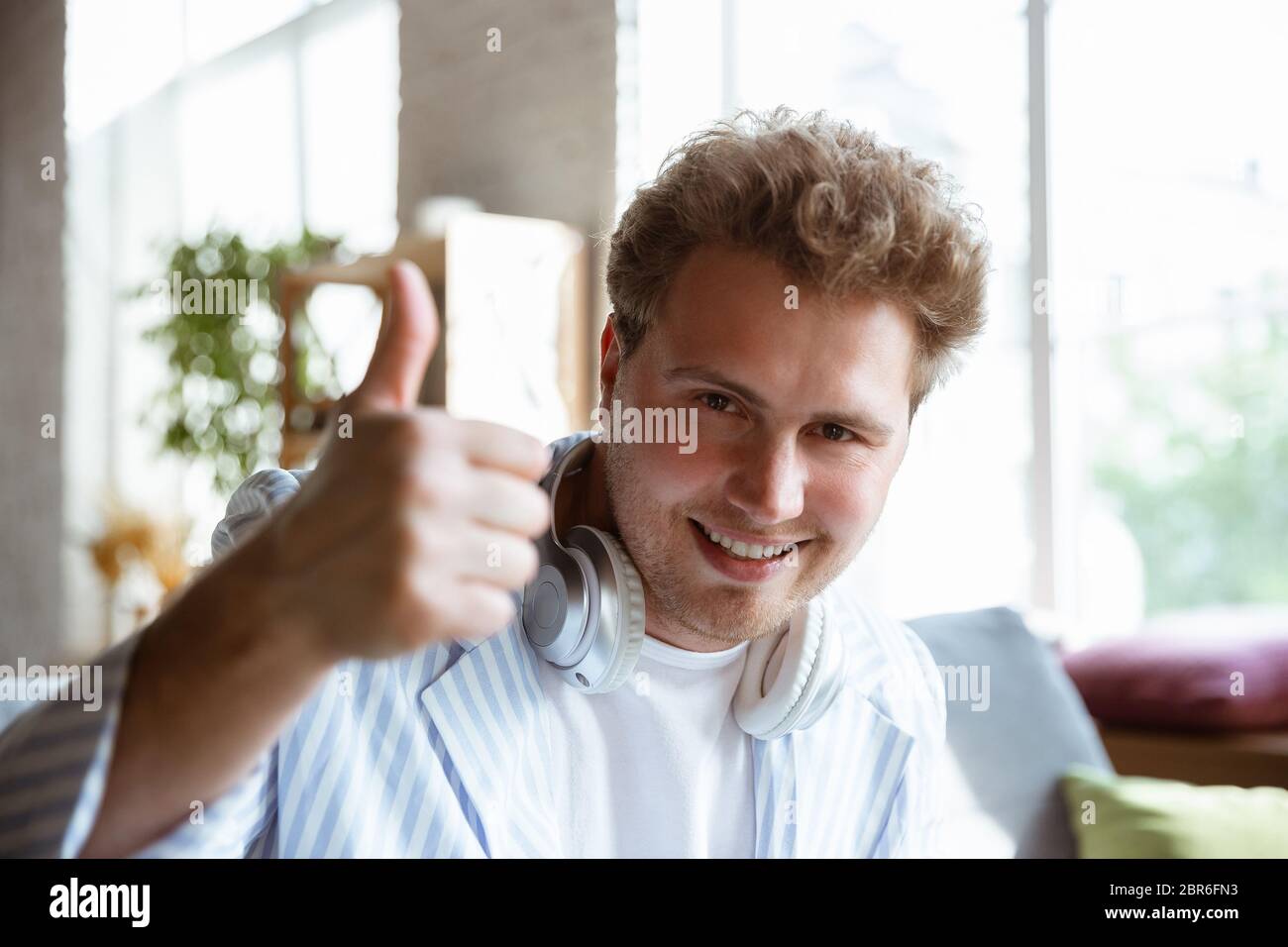Caucasian musician greeting audience before online concert or sound ...