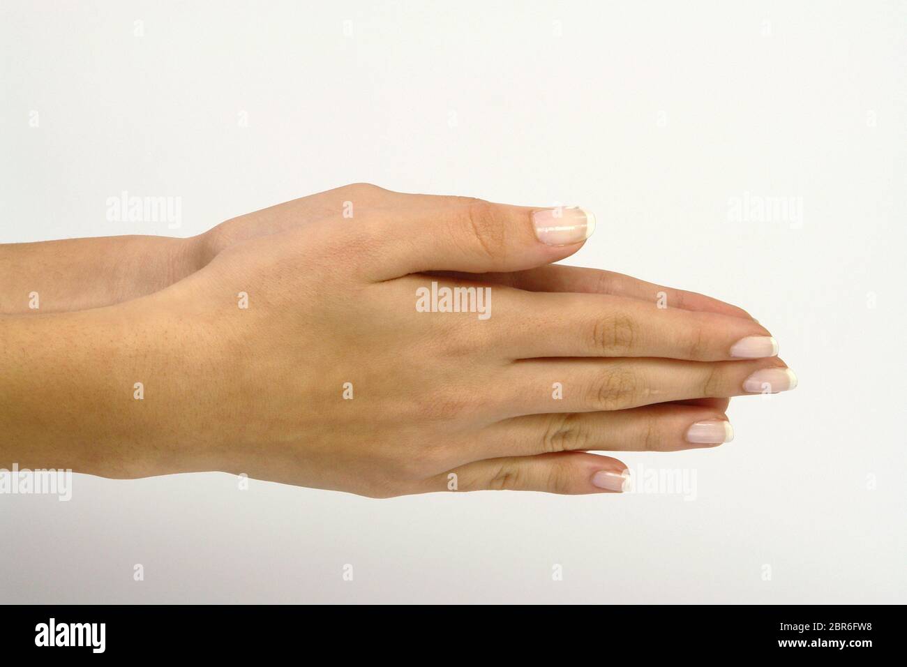 Closed woman hand isolated on white Stock Photo - Alamy