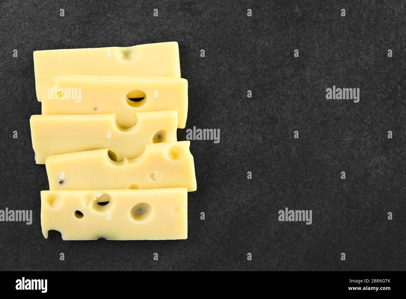 Slices of Emmental, Emmentaler or Emmenthal cheese on slate ...